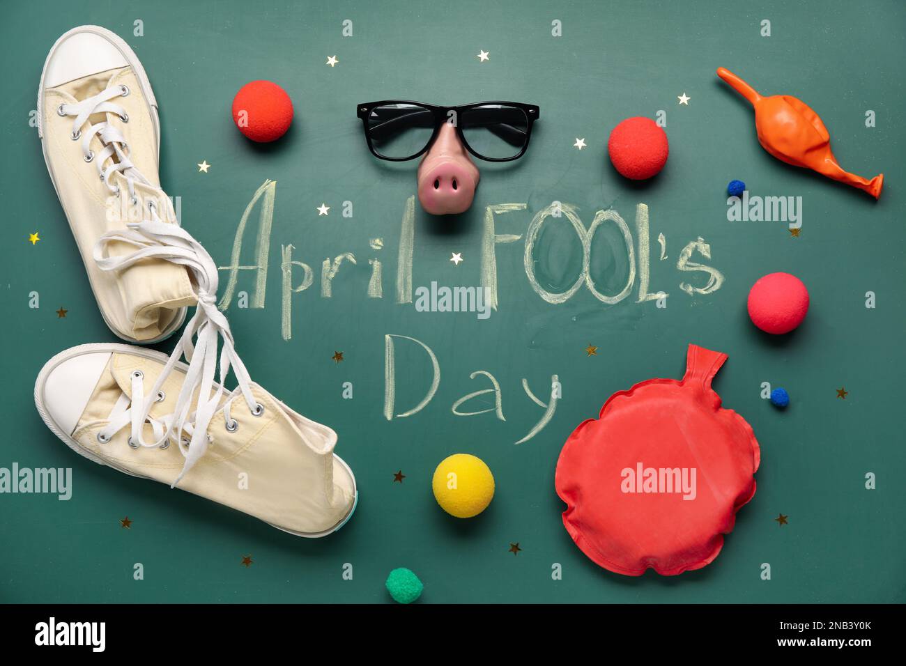 Composition with text APRIL FOOL'S DAY, shoes and party decor on ...