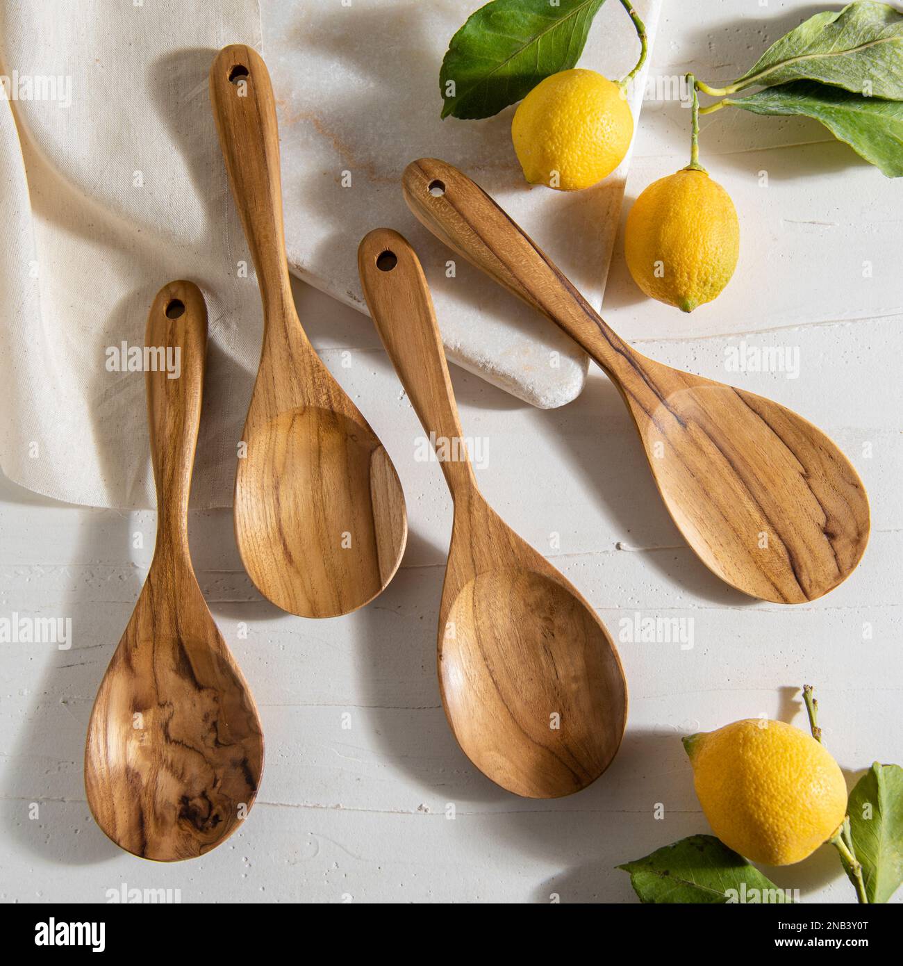 wooden spoons with lemons on white marble Stock Photo - Alamy