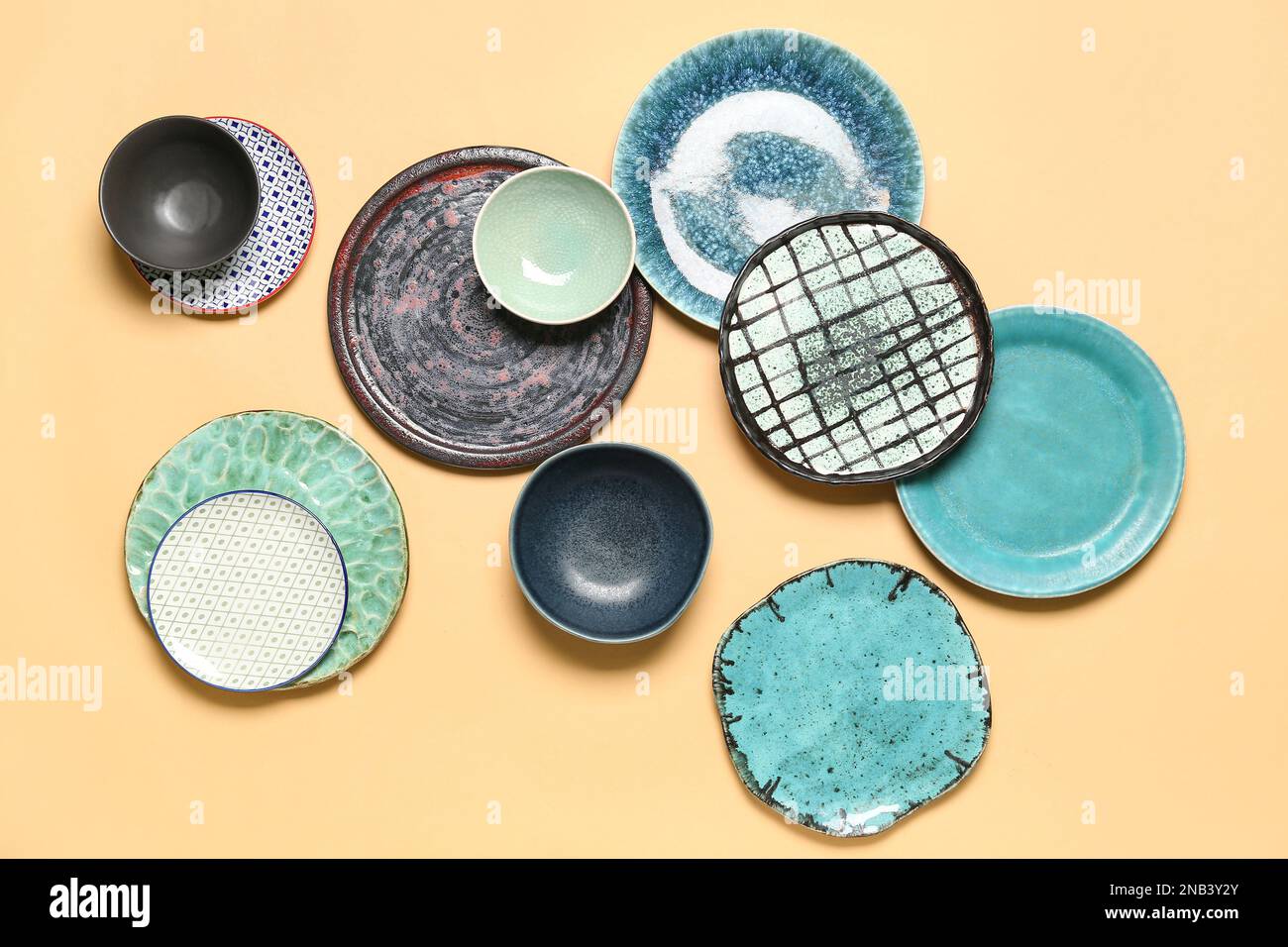 Set of different ceramic plates on color background Stock Photo - Alamy