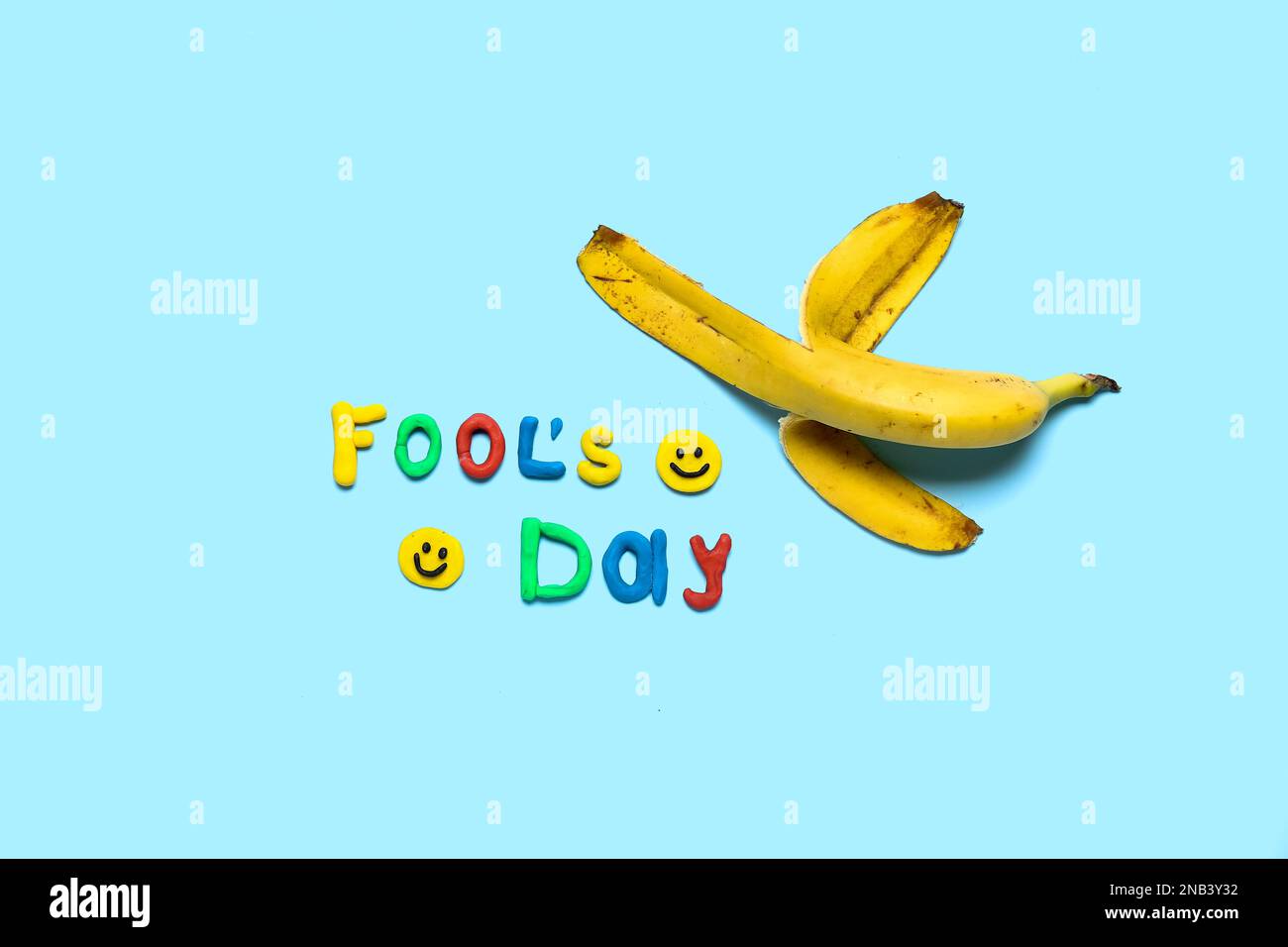 Text FOOL'S DAY made of plasticine and banana peel on color background ...