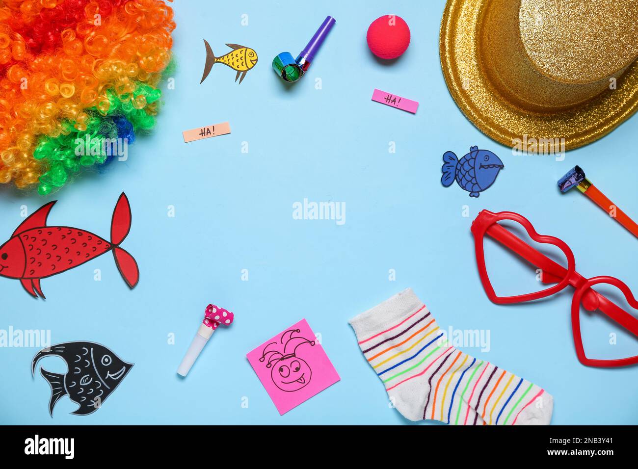 Frame made of party decor, sock and paper fishes on color background ...