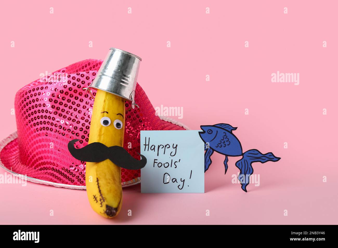 Sticky note with text HAPPY FOOL'S DAY, funny banana, hat and paper ...