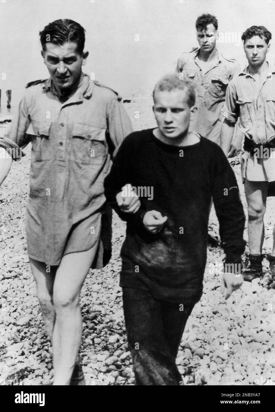 British prisoners captured during a raid, being led up the beach in ...