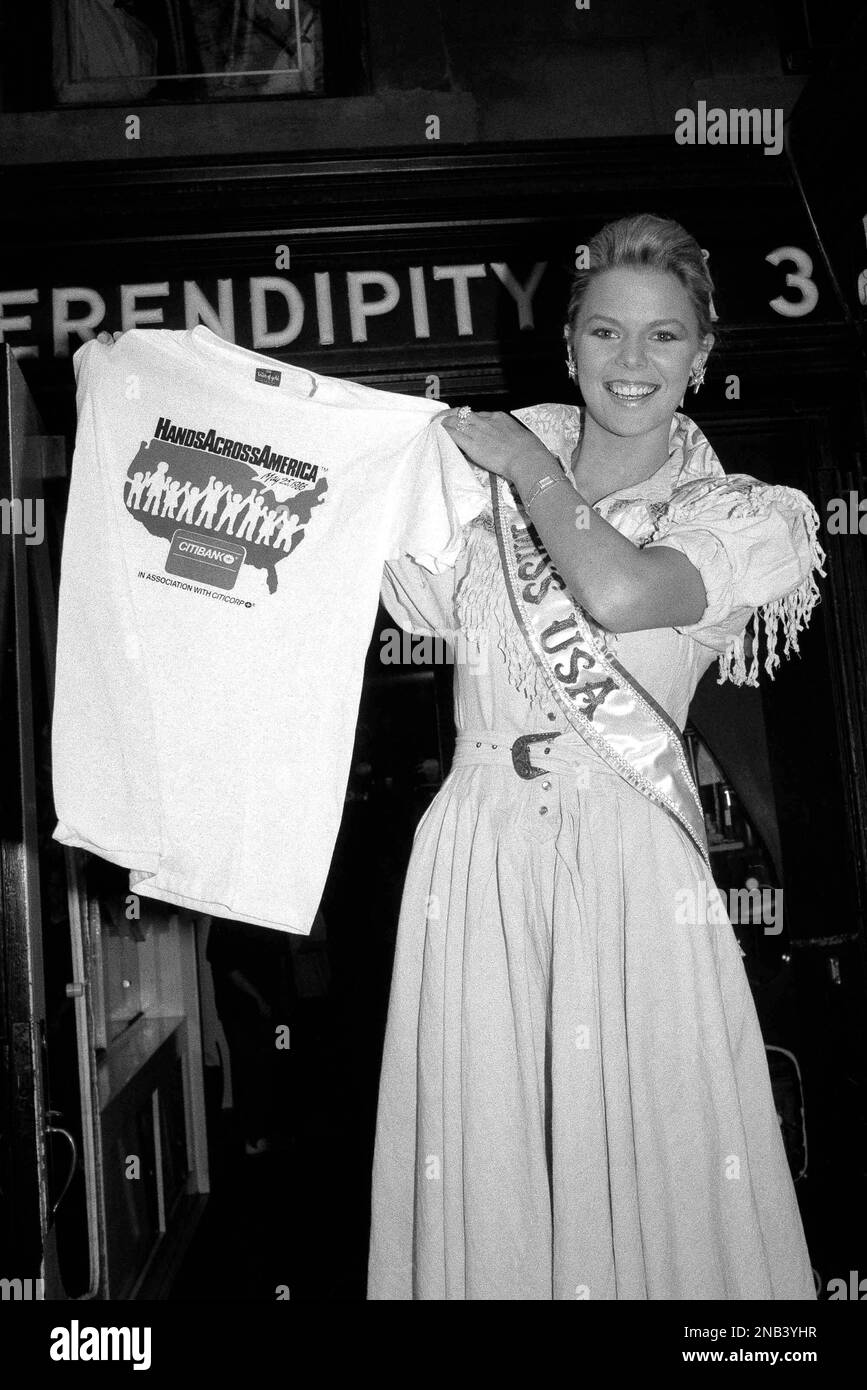 Miss USA Christy Fichtner holds up a “Hands Across America” T-shirt in ...