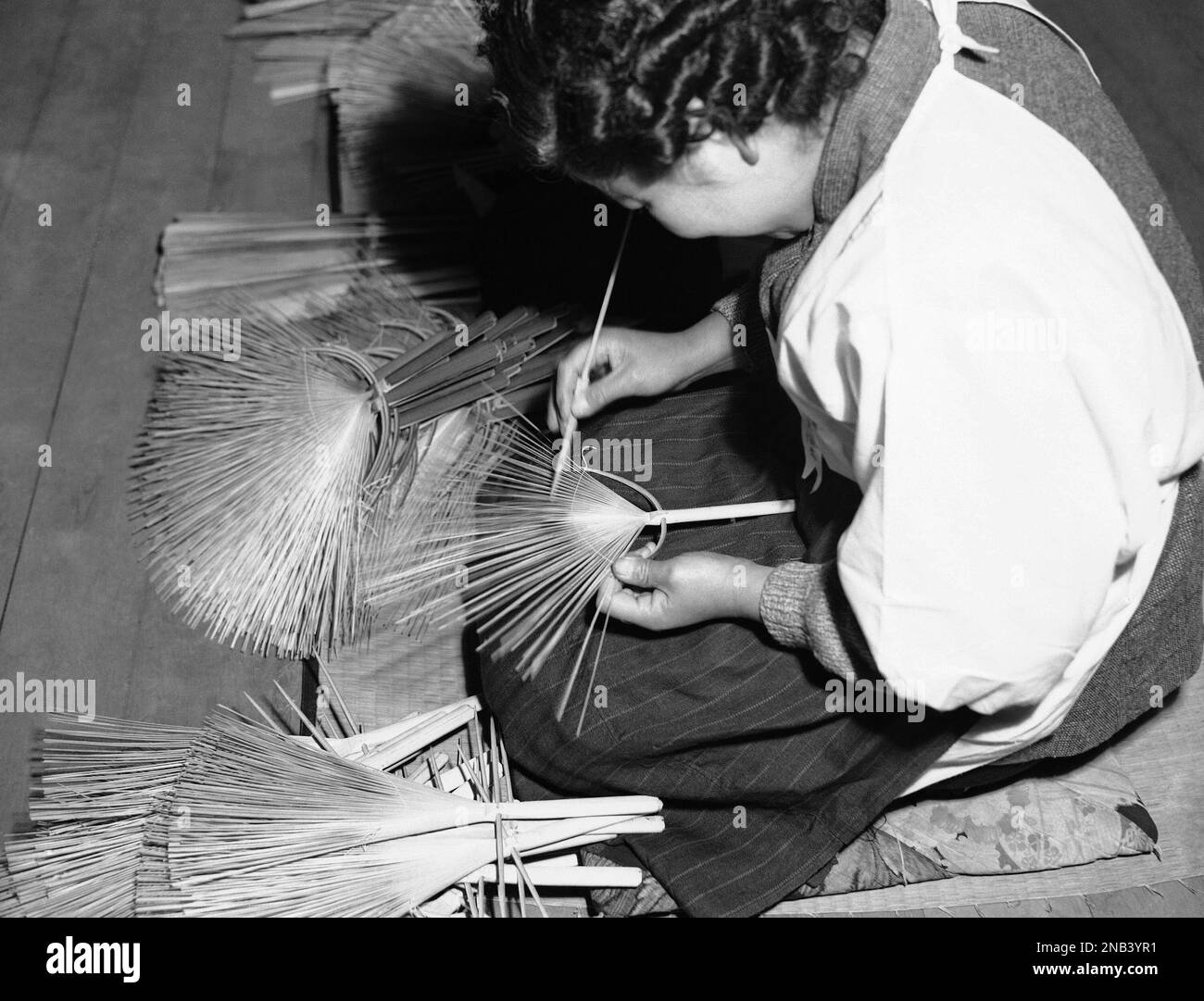 After splitting, the strips of bamboo are separated and a narrow piece ...