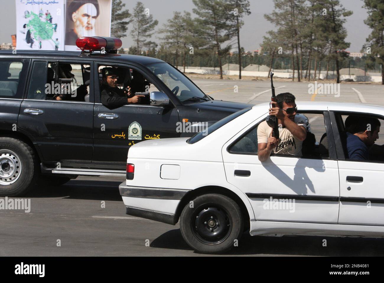 A member of Iranian police special forces, right, acting as a robber ...