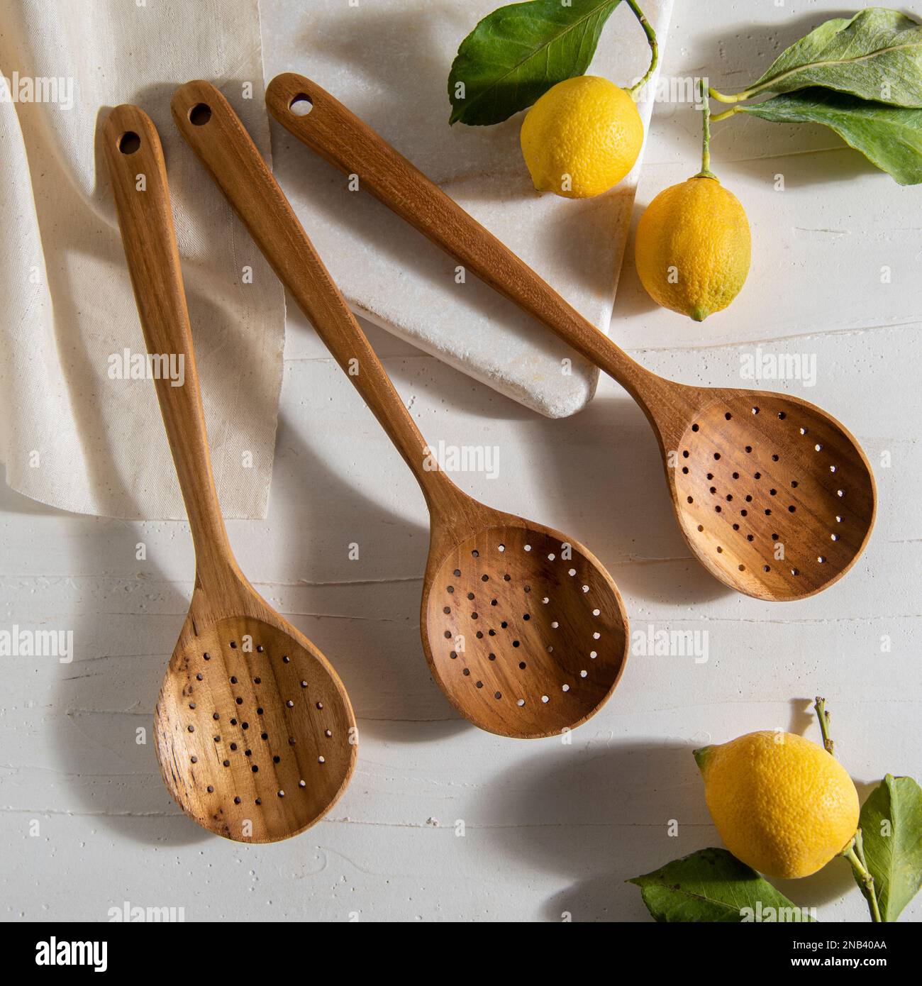 wooden spoons with lemons on white marble Stock Photo - Alamy