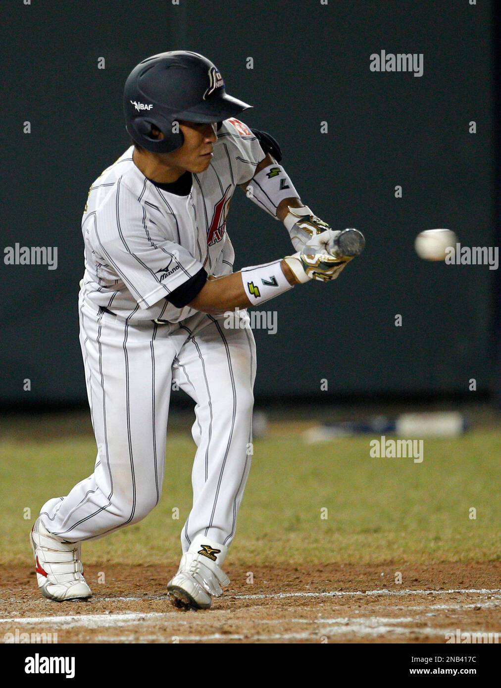 Japan's Takayoshi Kawabata bunts for a single in the fifth inning of ...