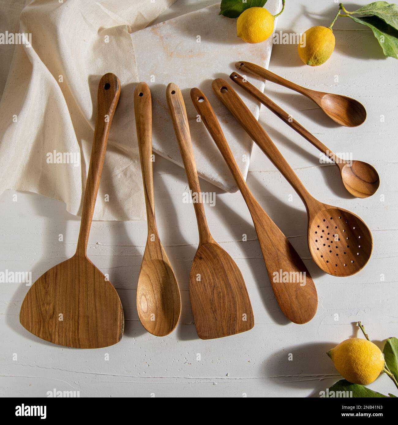 wooden spoons with lemons on white marble Stock Photo - Alamy