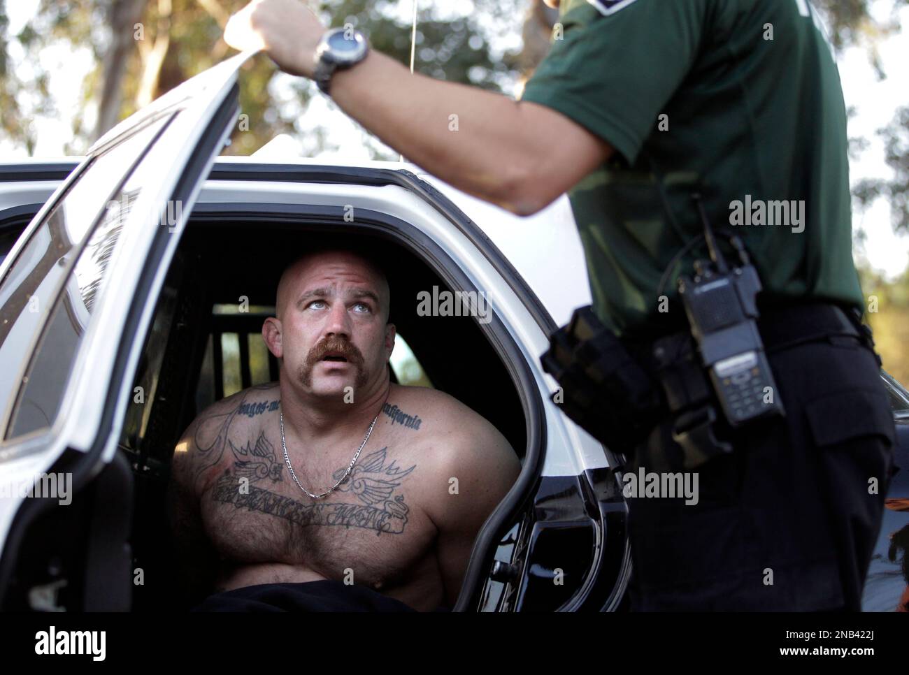 Andrew Lozano, a member of the Vagos motorcycle gang, talks to a ...