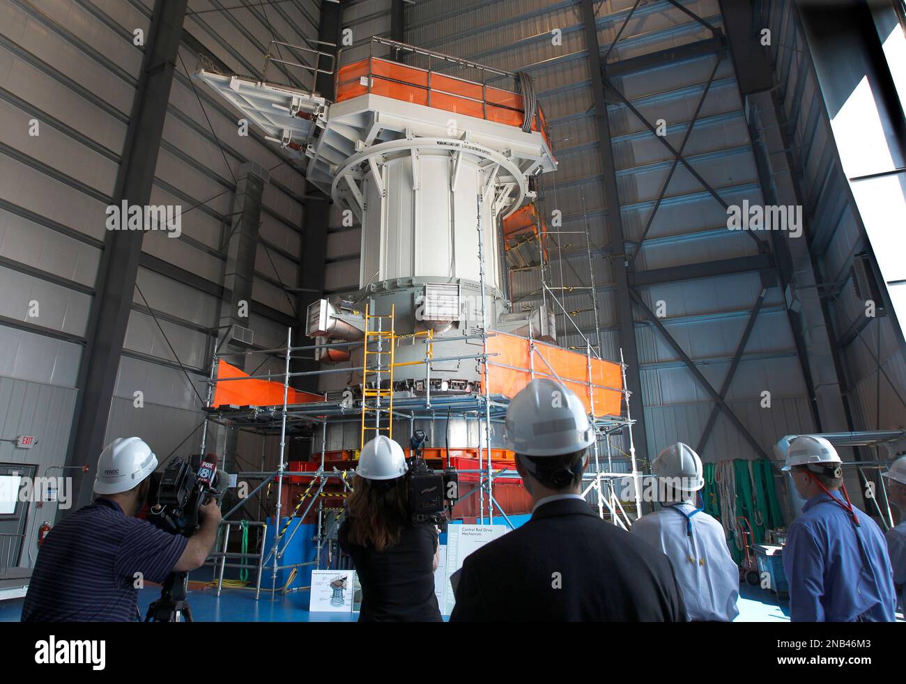 People look up at the new reactor head and assembly in a storage ...