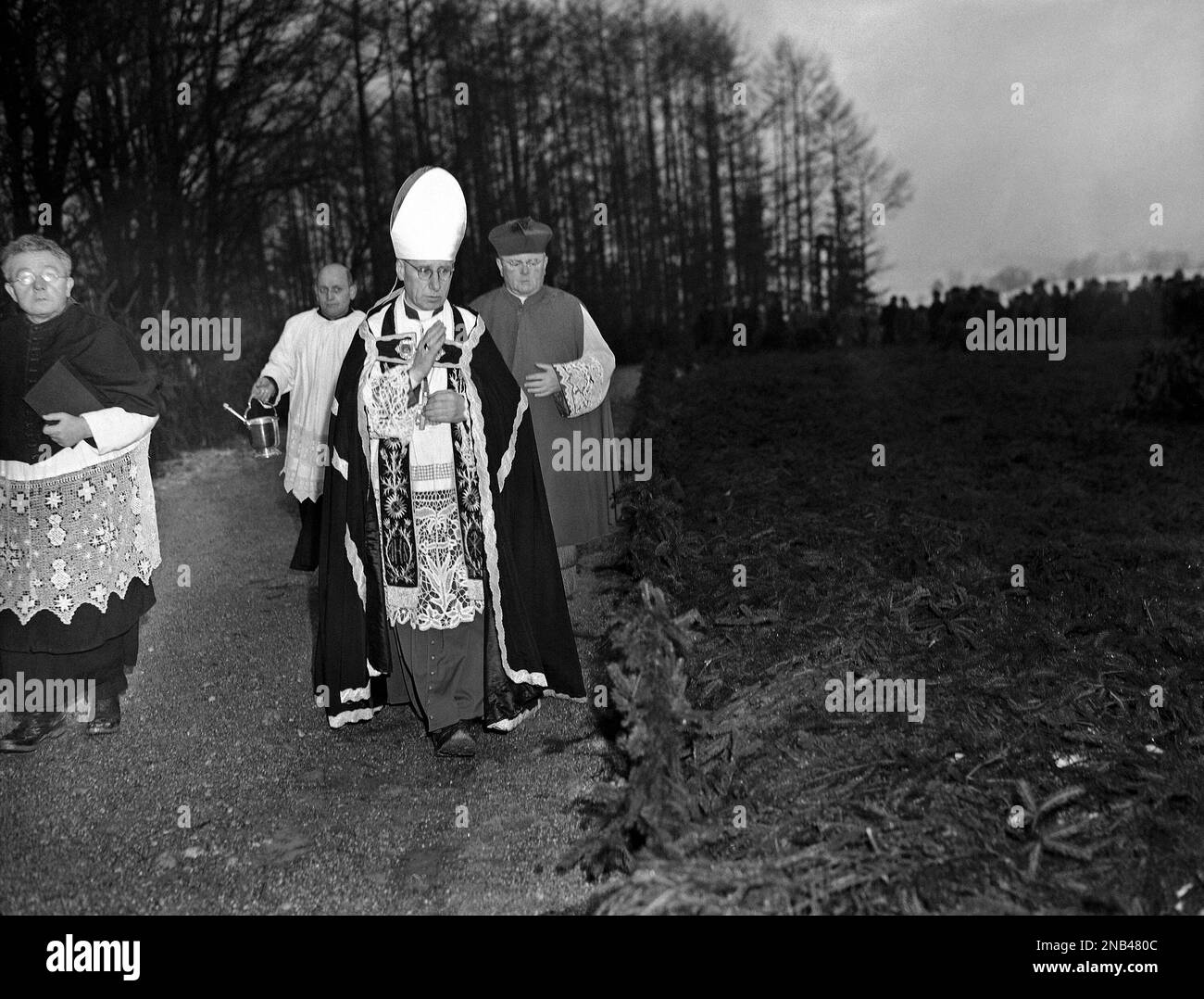 Bishop Dr. Johannes Neuhaeussler consecrating the mass grave of ...