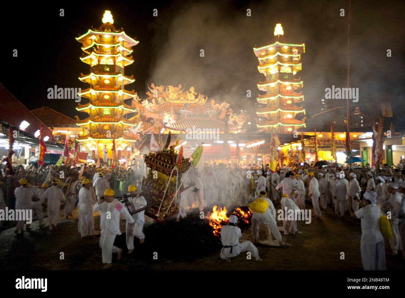 Malaysian Chinese carrying an Emperor God walk barefoot over burning ...