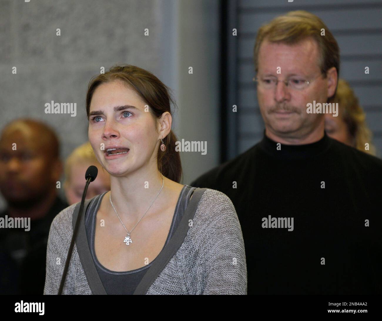 Amanda Knox talks to reporters as her father, Curt Knox, right, stands ...