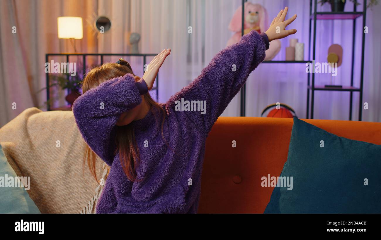 Trendy cheerful positive toddler girl having fun dancing, moving to ...