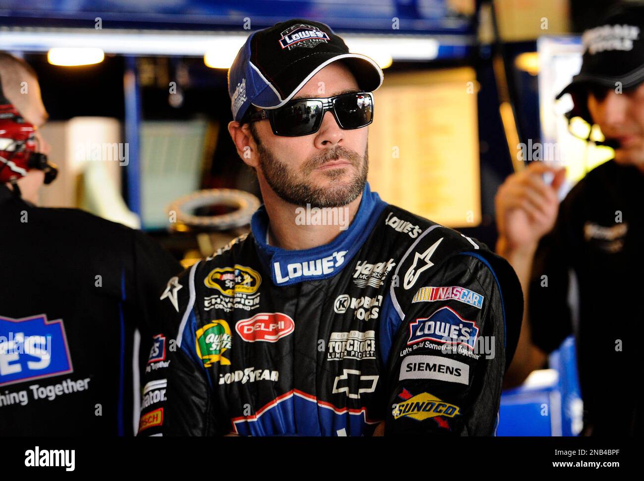 Driver Jimmie Johnson stands in his team's garage before a practice ...