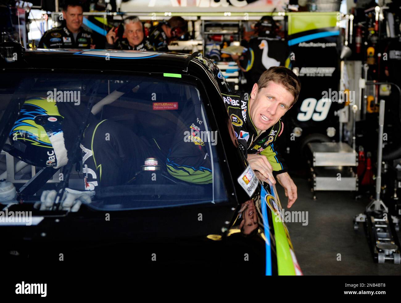 Carl Edwards climbs into his car during a practice session for the AAA ...