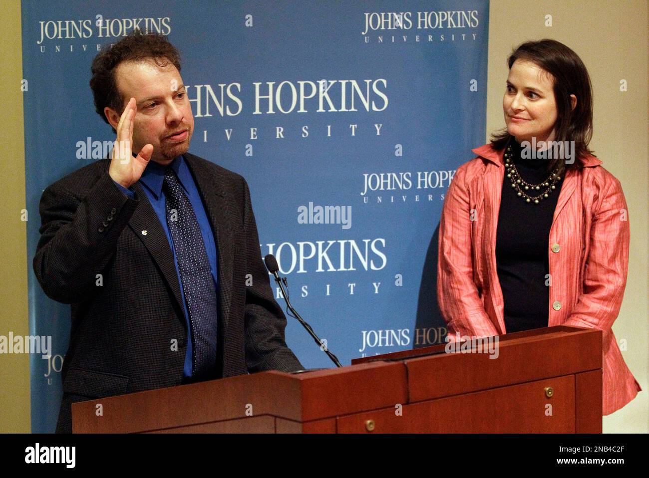 Dr. Adam Riess, left, speaks alongside his wife Nancy at a news ...