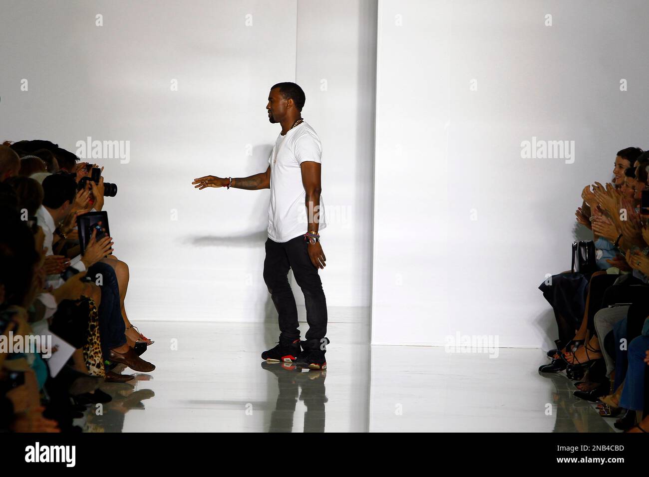 Rap singer Kanye West reacts after his spring-summer 2012 ready-to-wear ...