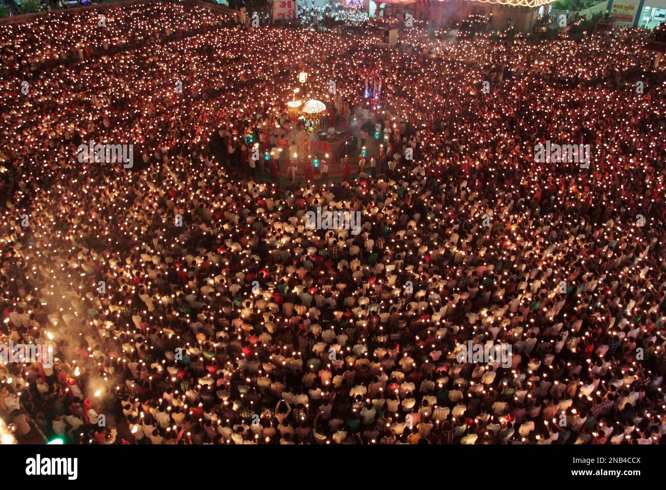 Indian devotees holds earthen lamps and take part in Maha Aarti ritual ...