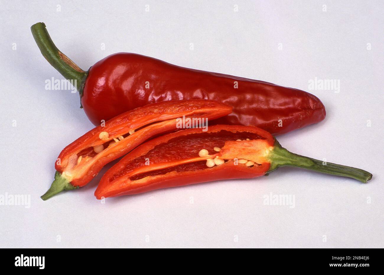 STUDIO IMAGE OF FULL AND SLICED RED CHILLI PEPPERS Stock Photo - Alamy