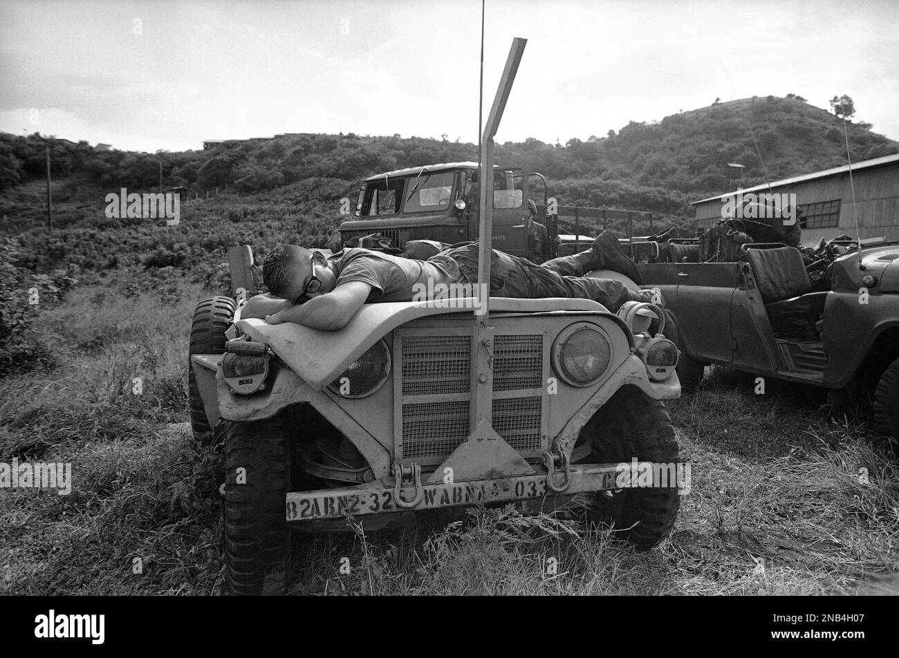 A U.S. Army soldier takes a nap on top of a jeep inside the captured ...