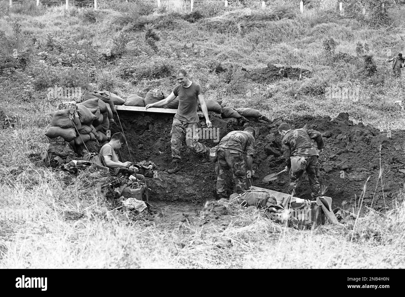 U.S. Army soldiers work to build a bunker on the perimeter of the ...