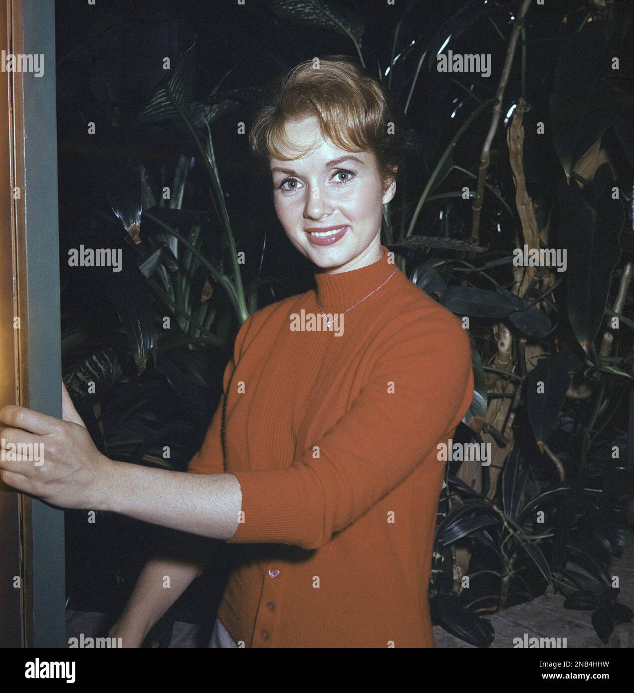 Actress Debbie Reynolds wears red and gray outfit, as seen at home Los ...