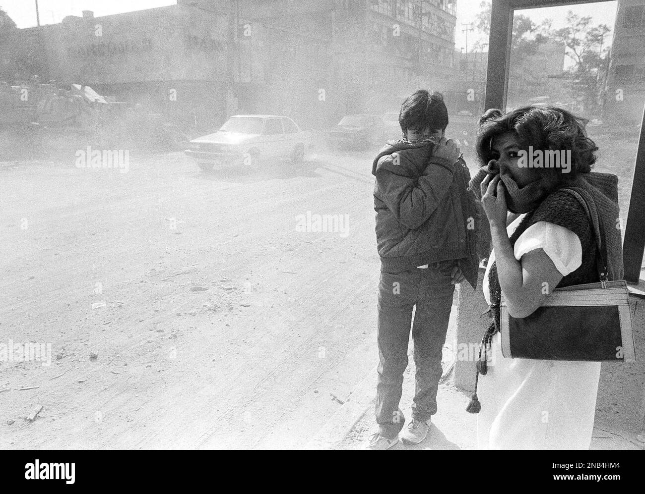 Clouds of dust fill the air and residents protect their lungs. The dust ...