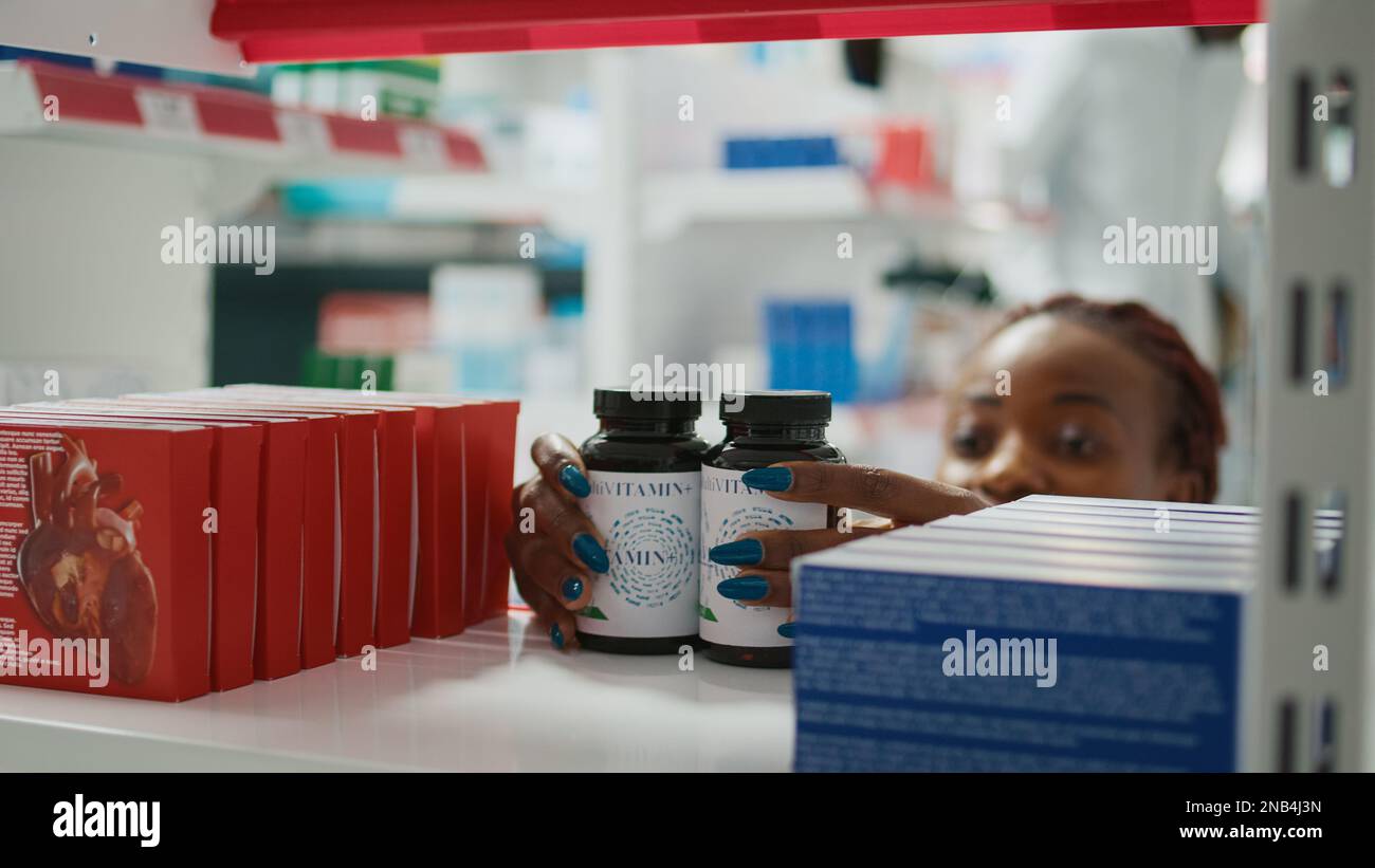 Female pharmacist arranging boxes hi-res stock photography and images ...