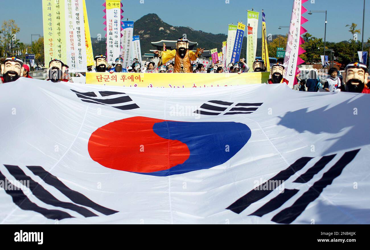 South Koreans wearing masks of Dangun, the legendary founder of ...
