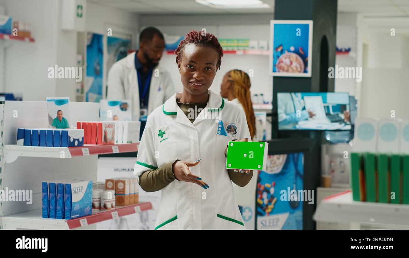 Health specialist pointing at medicine box with greenscreen, howing ...