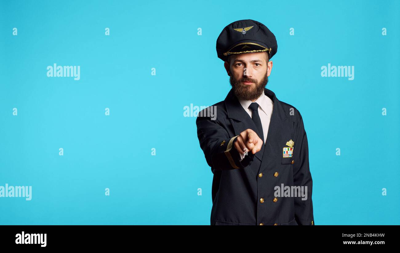 Airplane pilot in uniform pointing at camera and choosing, saying i ...