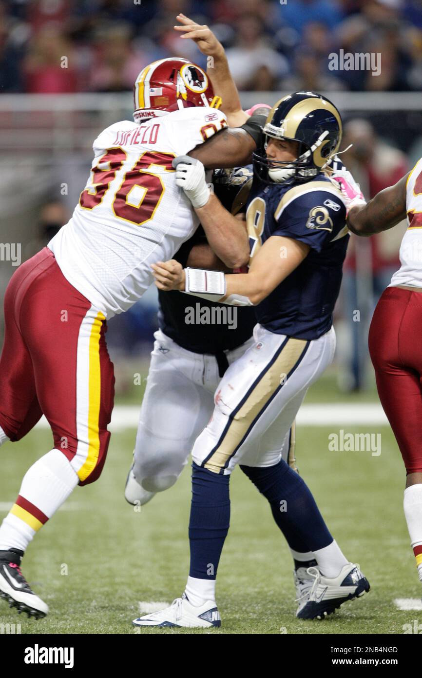 St. Louis Rams quarterback Sam Bradford is hit hard by Washington ...