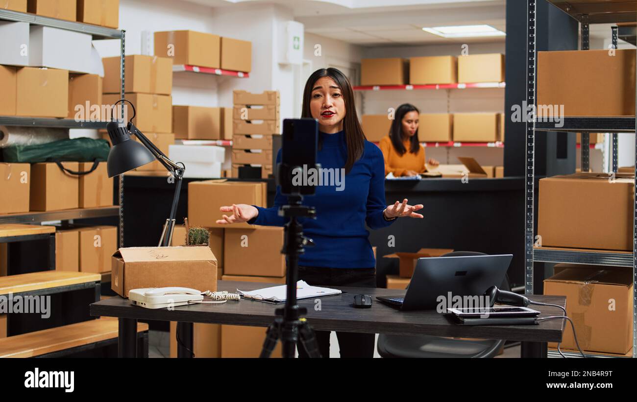 Business owner working on digital marketing with video, filming vlog ...