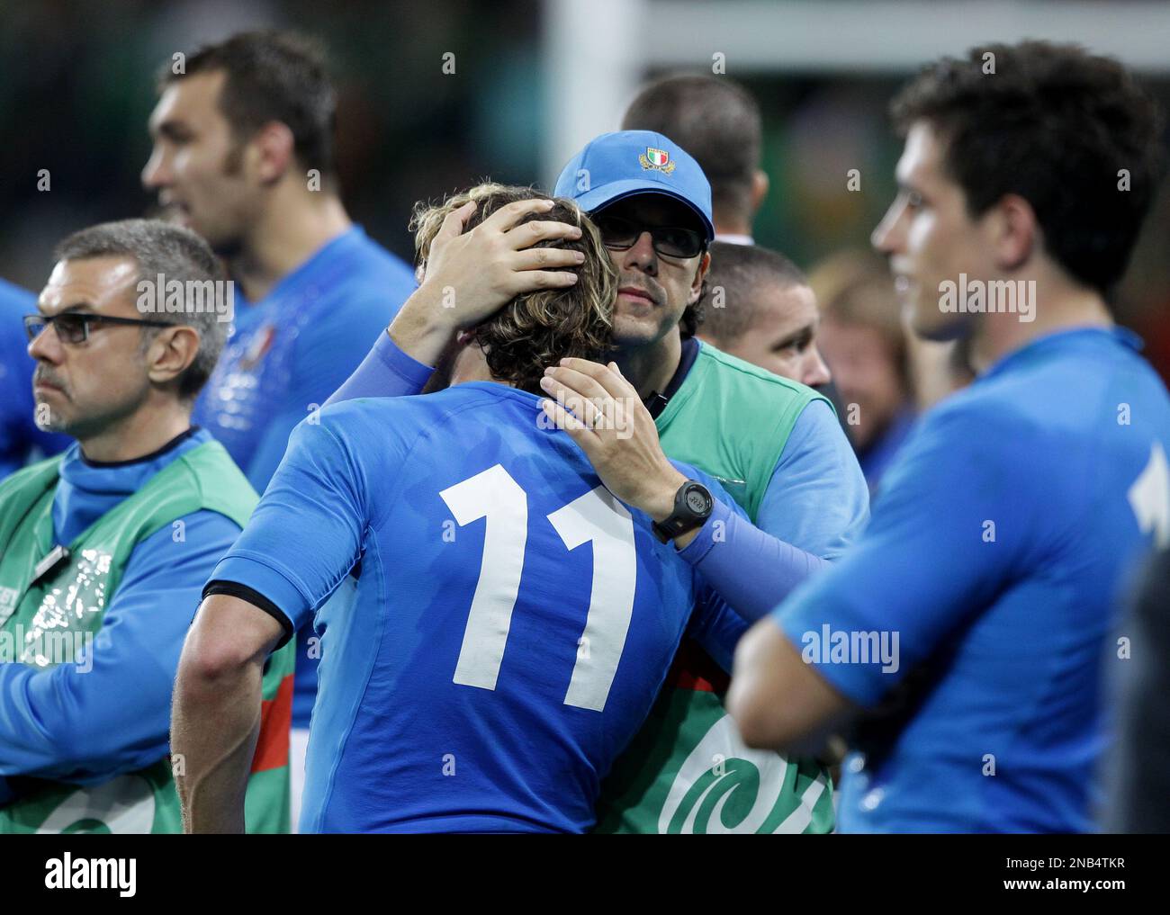Italy's Mirco Bergamasco is consoled by a team official after losing ...