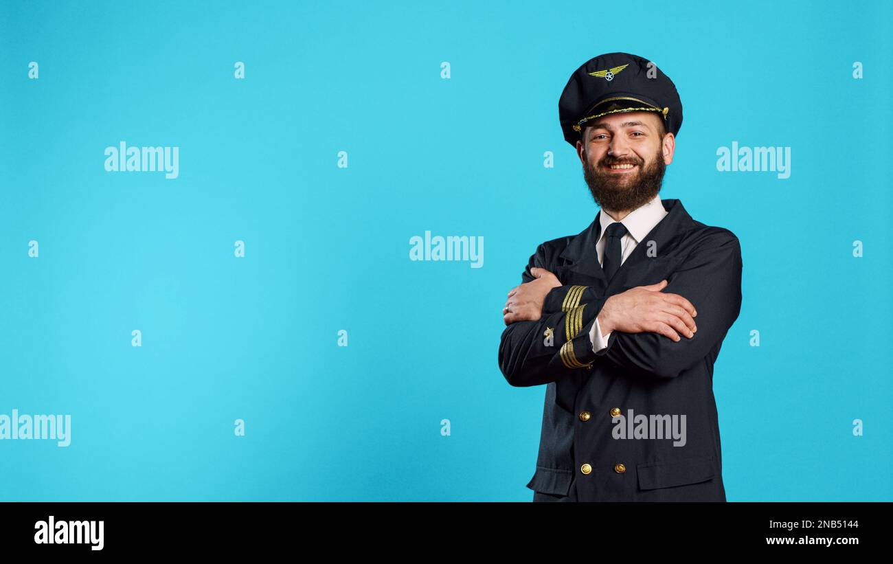 Portrait of smiling aircrew captain posing on camera, acting positive ...