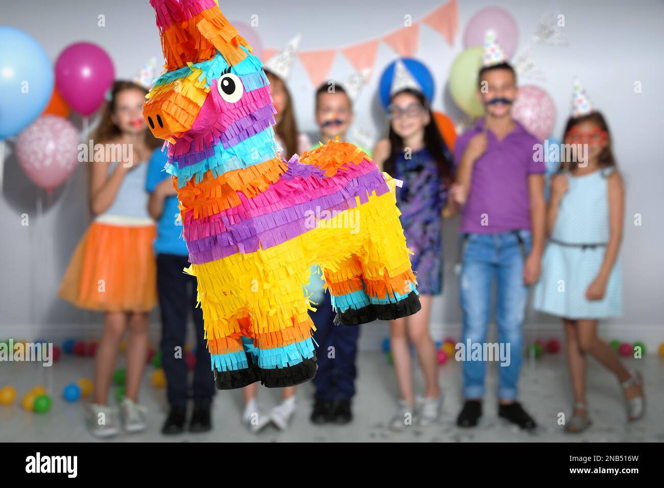 Bright festive pinata hanging indoors at birthday party Stock Photo - Alamy