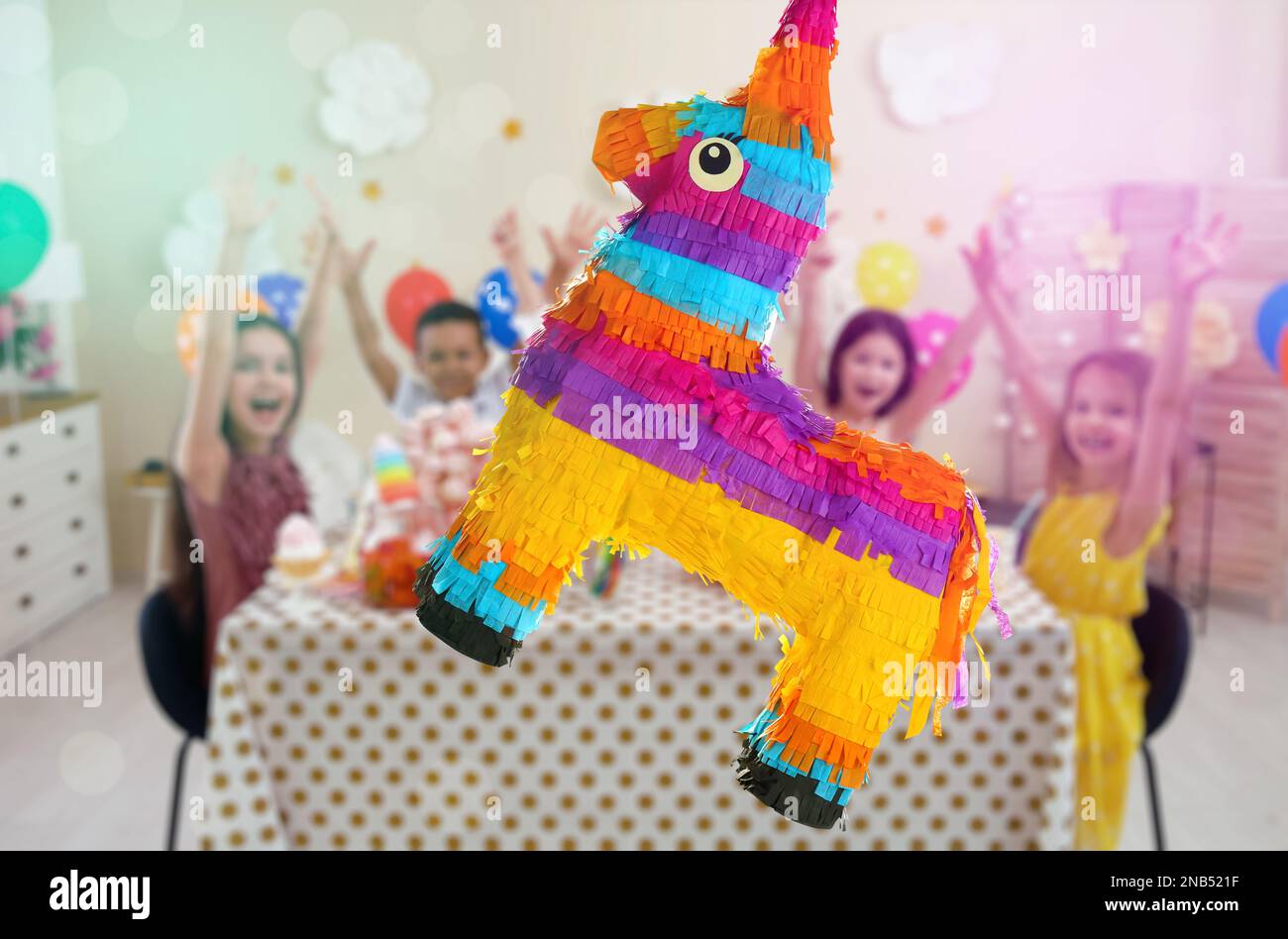 Bright festive pinata hanging indoors at birthday party Stock Photo - Alamy
