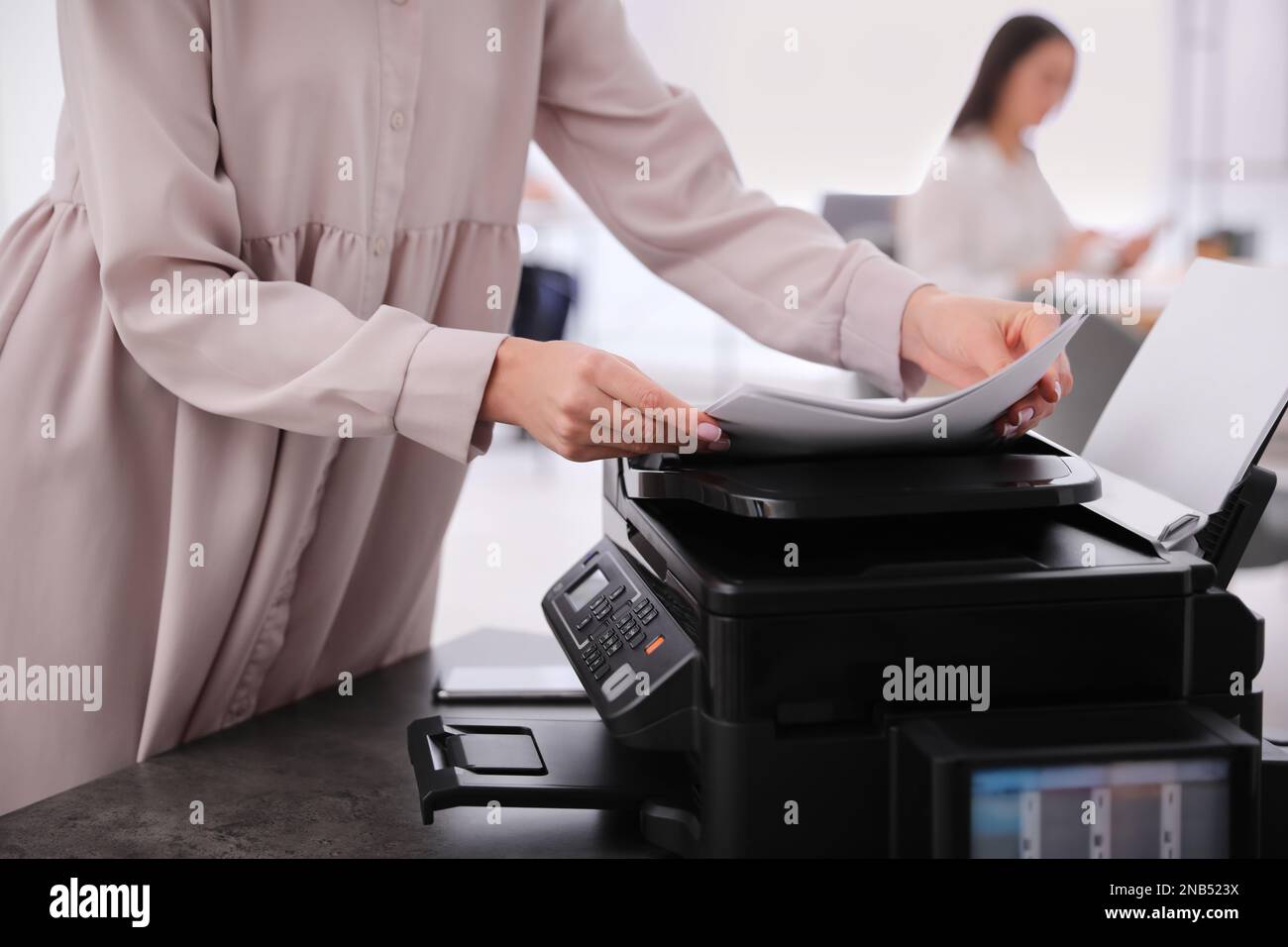 Employee using modern printer in office, closeup Stock Photo - Alamy