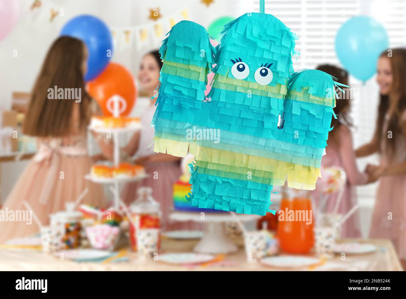 Bright festive pinata hanging indoors at birthday party Stock Photo - Alamy