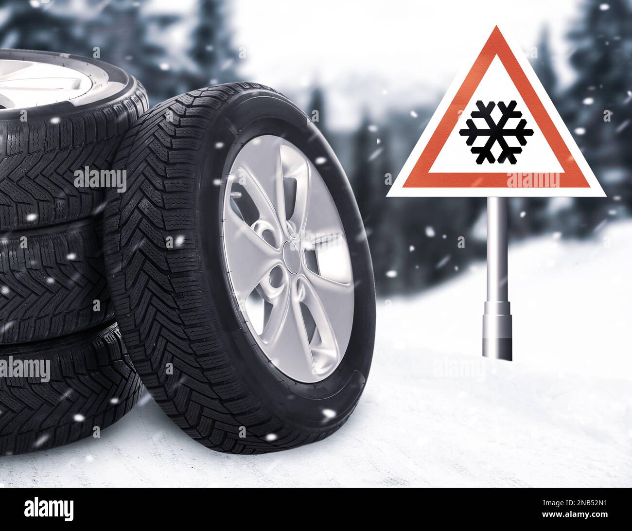 Set of wheels with winter tires on snow and road sign outdoors Stock ...