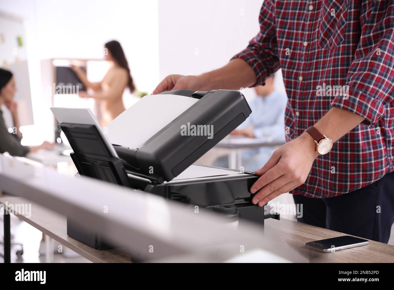 Employee using modern printer in office, closeup Stock Photo - Alamy
