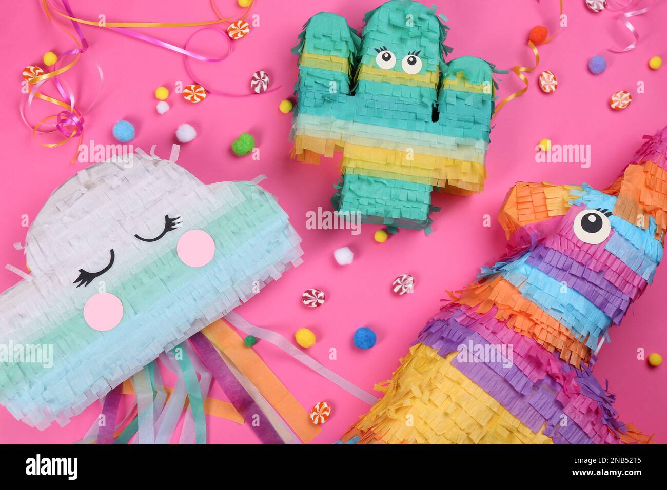 Different bright pinatas on pink background, flat lay Stock Photo - Alamy