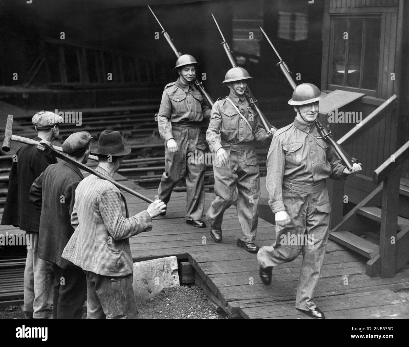 Three British Home Guardsmen patrol a London railway terminus on August ...