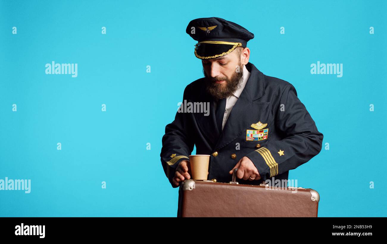 Airline pilot carrying briefcase baggage at job, preparing for ...