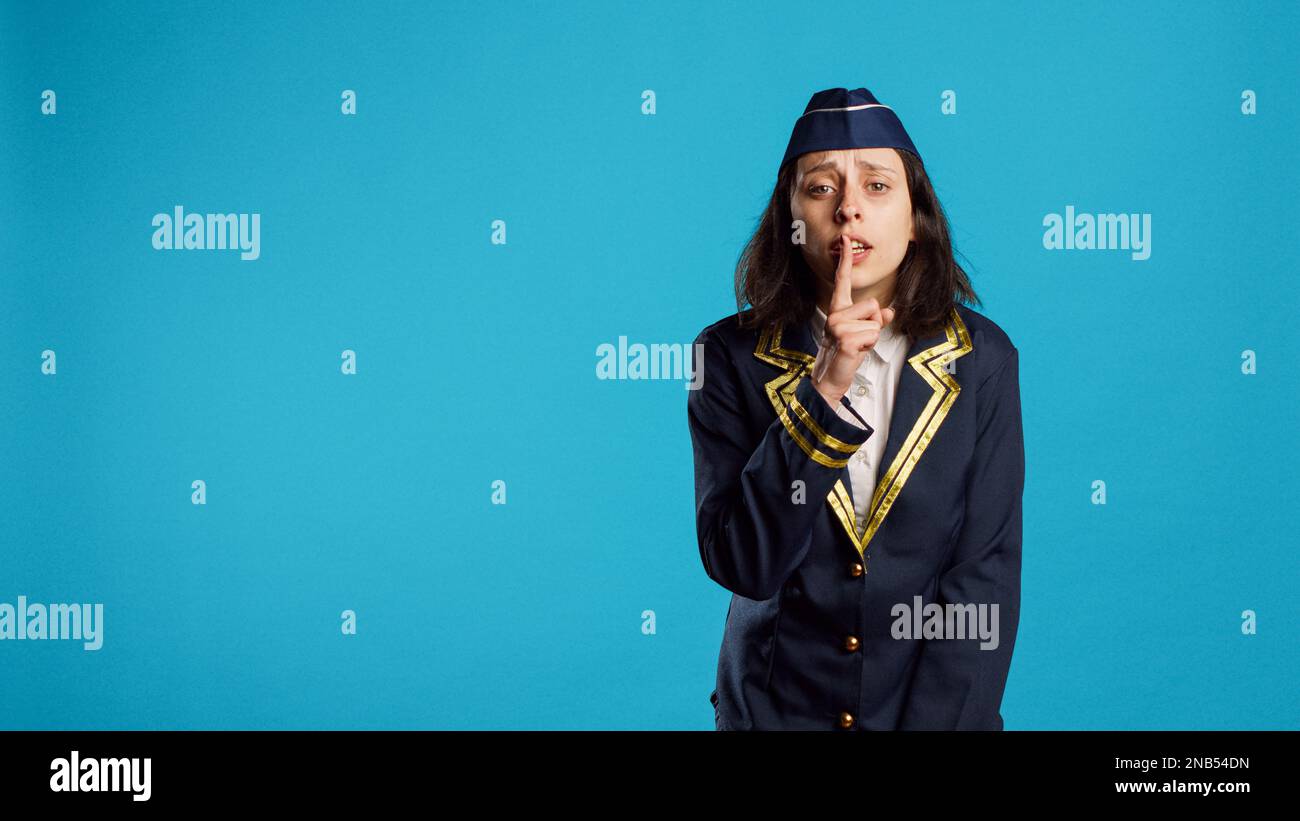 Professional airliner doing hush silent symbol on camera, acting ...