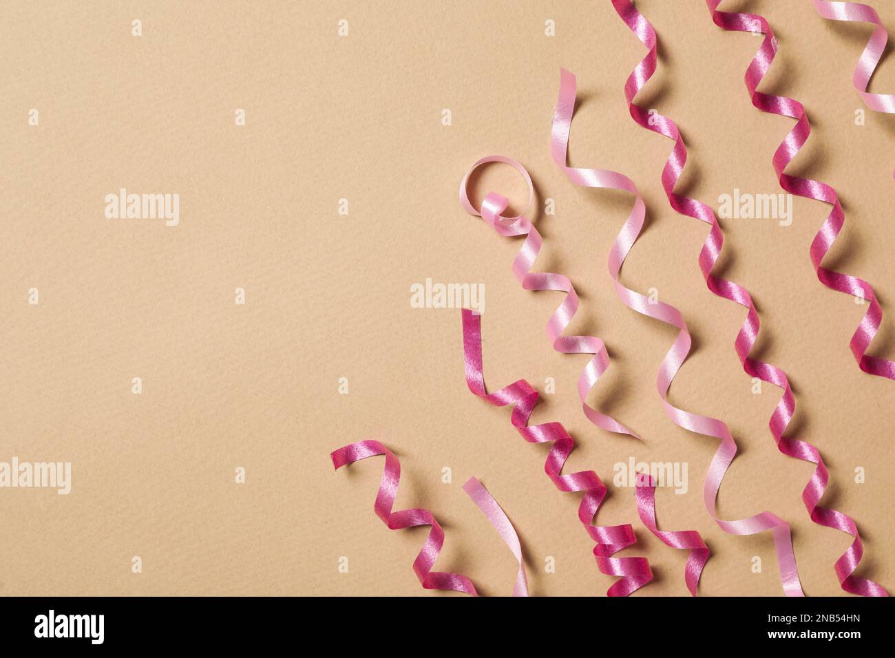 Shiny serpentine streamers on pink hi-res stock photography and images ...