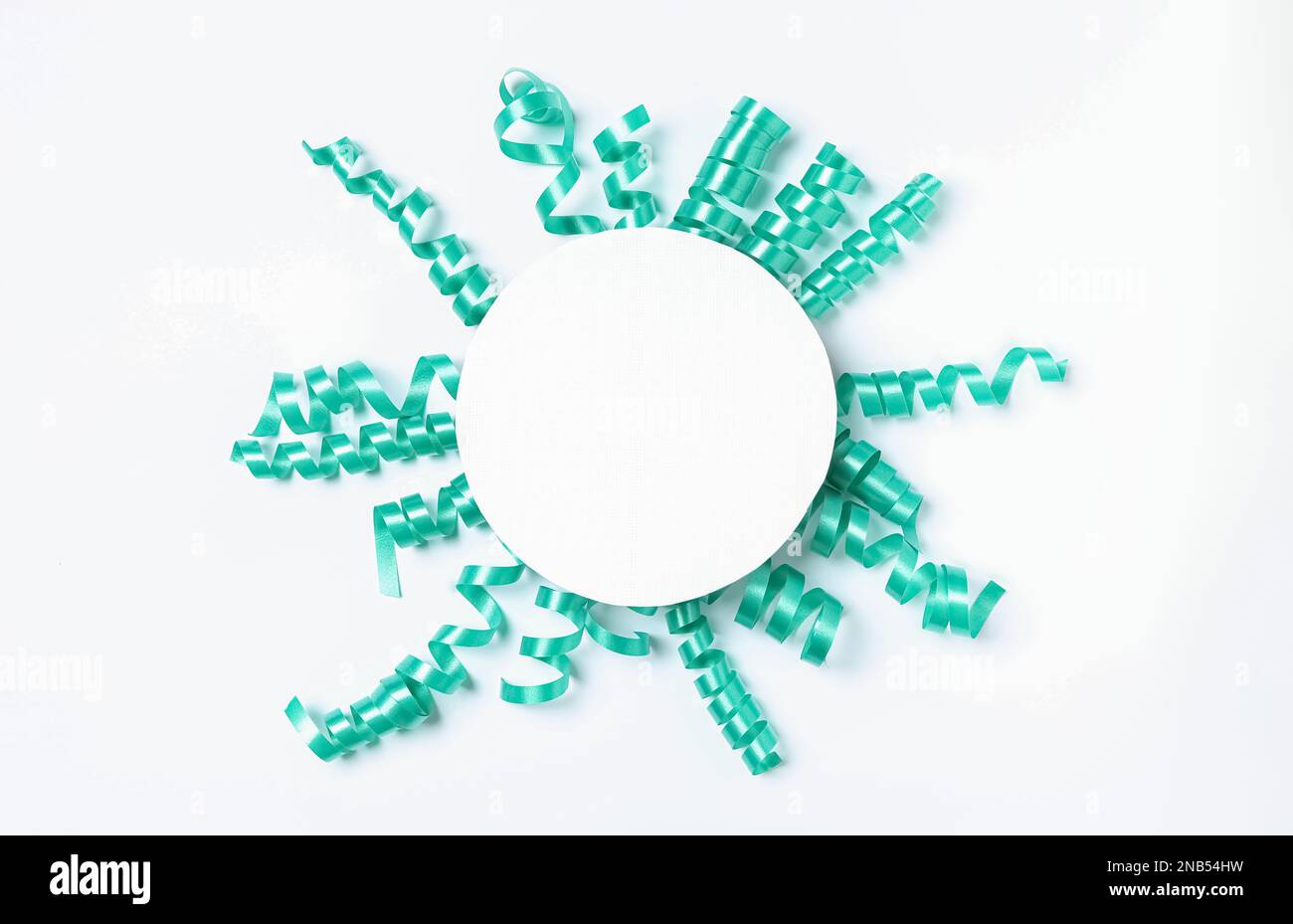 Blank card and turquoise serpentine streamers on white background, top view Stock Photo - Alamy