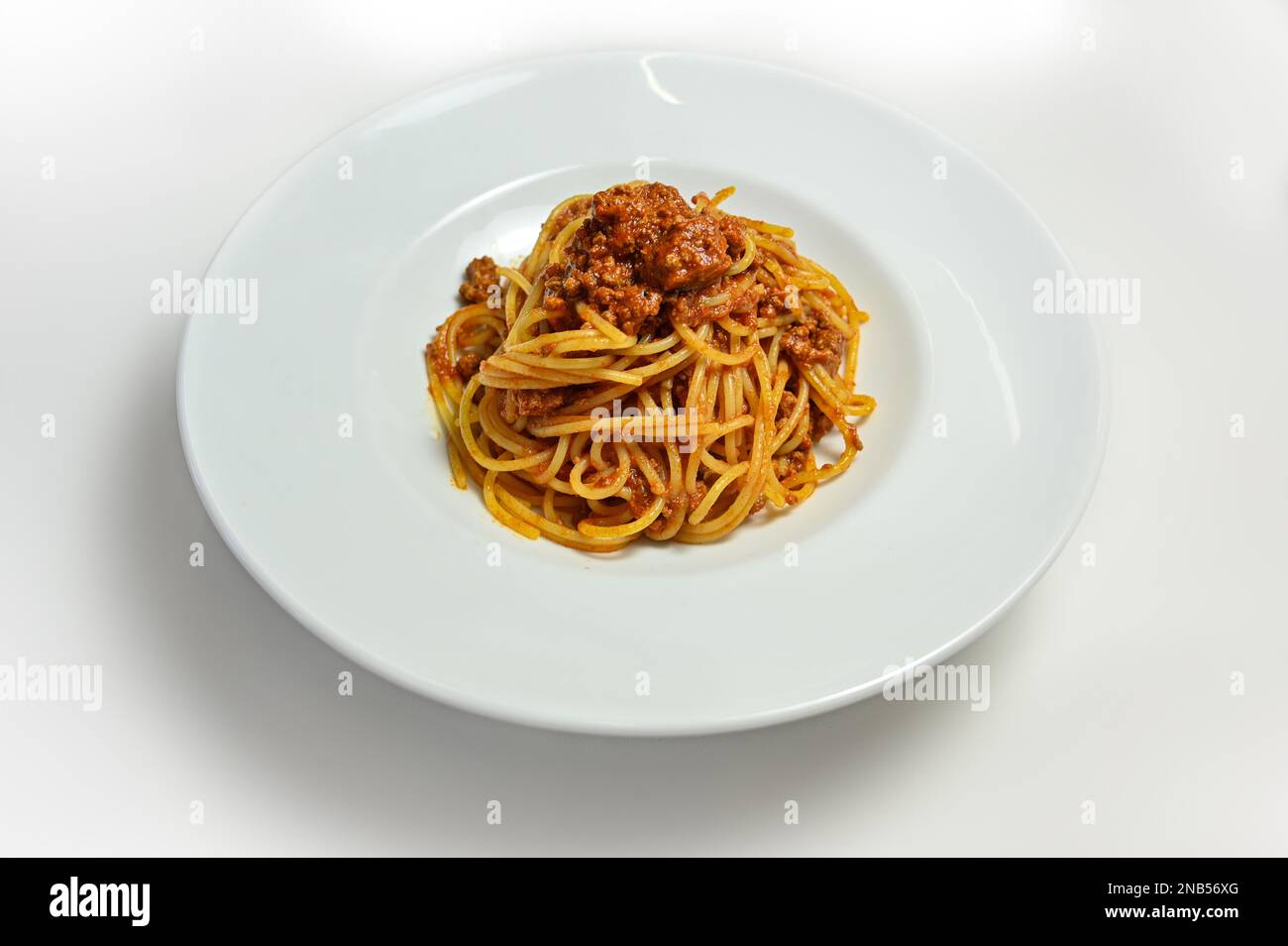 A gourmet plate of bolognese spaghetti isolated on a white background ...